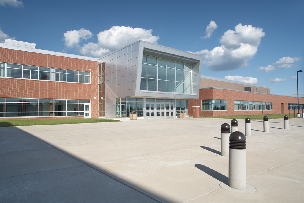 Exterior View of School with Dark Tan Brick Facade and Unique Entrance ...