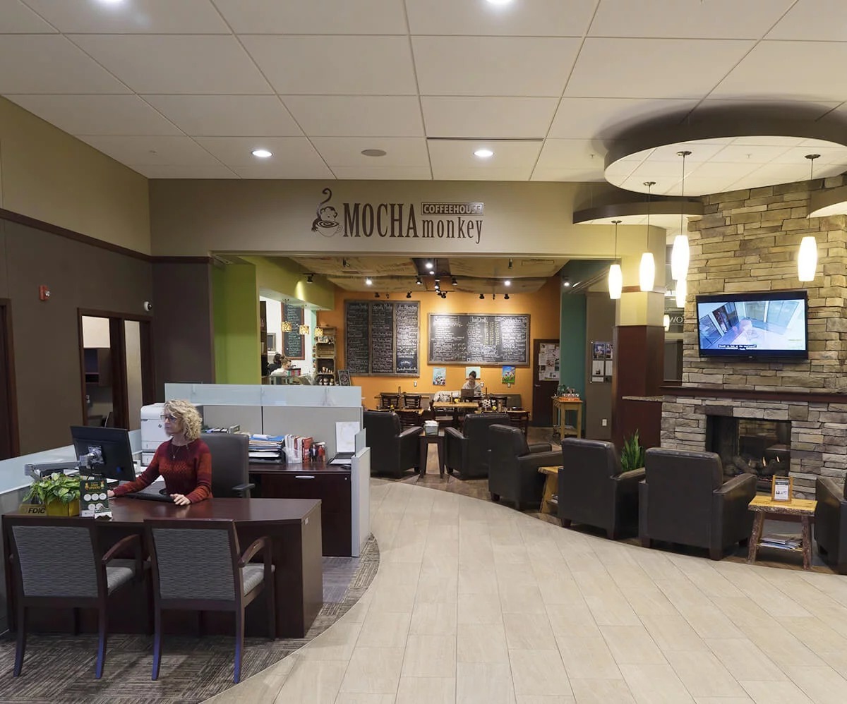 HTG Architects HomeTown Bank Cosy Interior Stone Fireplace | HTG Architects